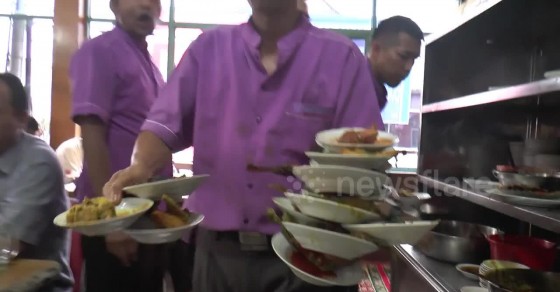 Talented waiter carries 17 food-filled plates at once in an Indonesian ...
