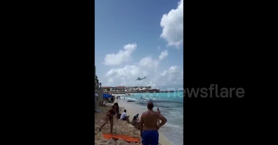 Beachgoers watch as planes fly low over Caribbean beach - Sharedots