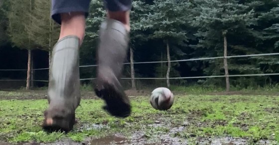 Wellies Go Flying During Muddy Football Kick - Sharedots
